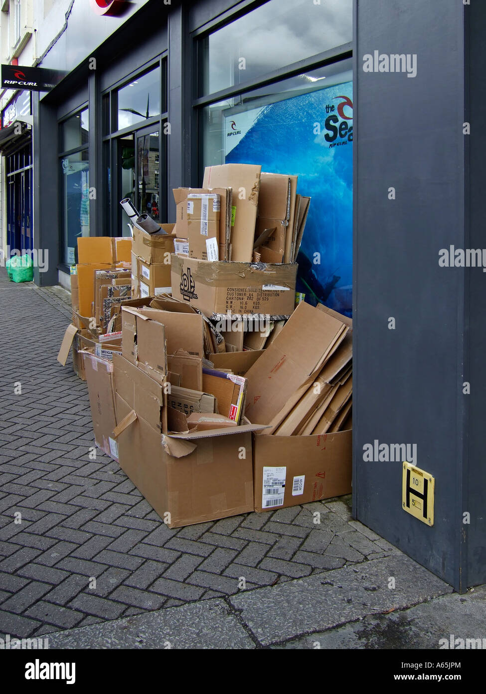 empty cardboard boxes waiting to be collected for recycling outside a ...