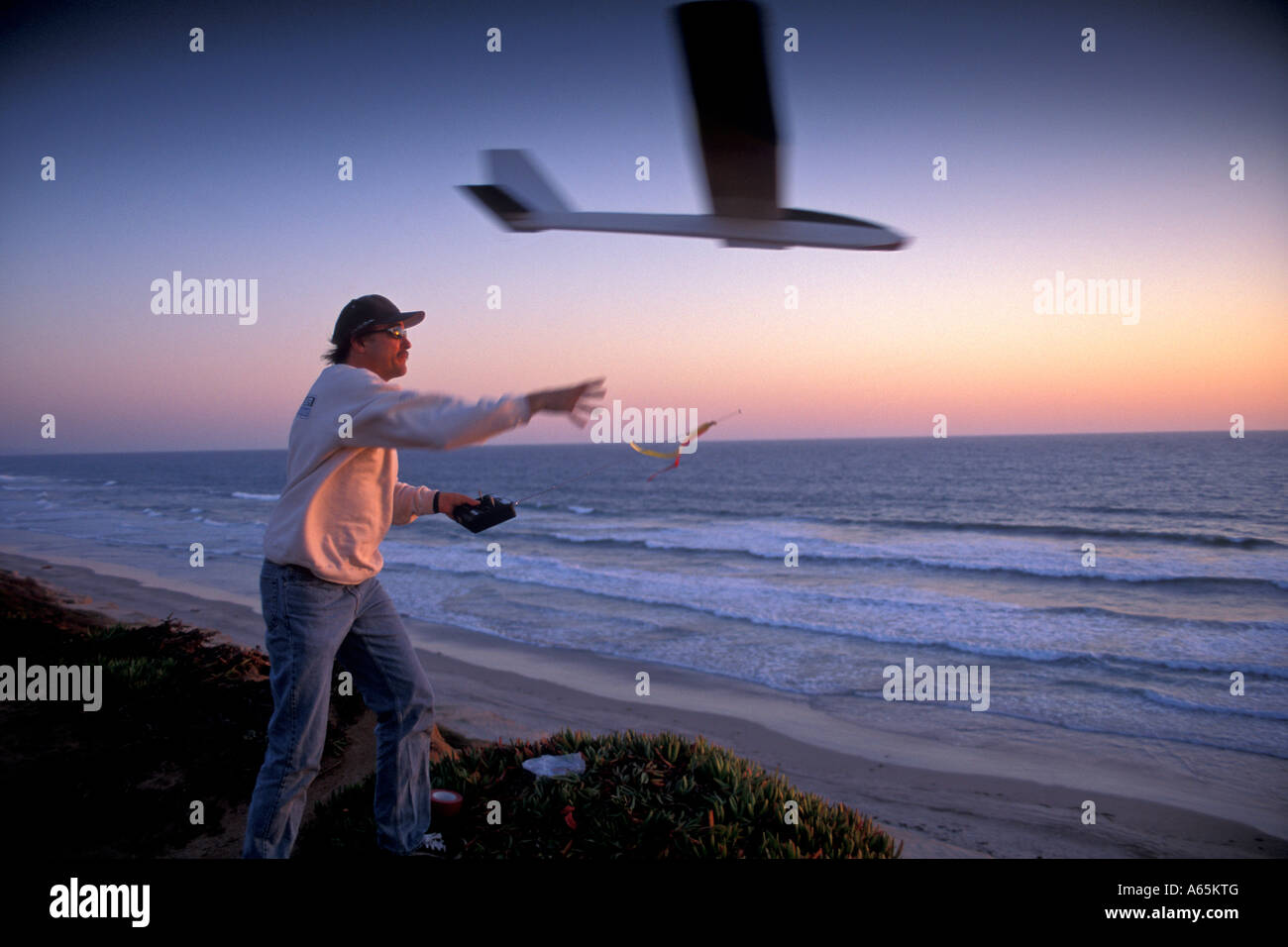 Gary Legerton flying radio glider at sunset over the Pacific Ocean ...