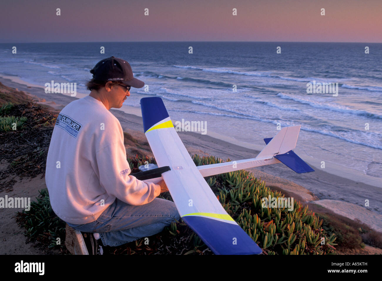 Gary Legerton flying radio glider at sunset over the Pacific Ocean ...