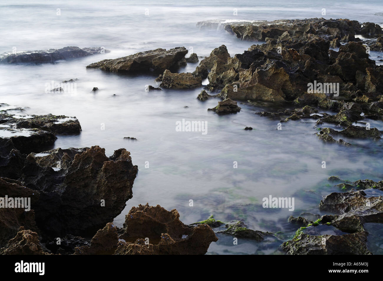 jagged coastal rocks and waves photographed using time exposure to ...