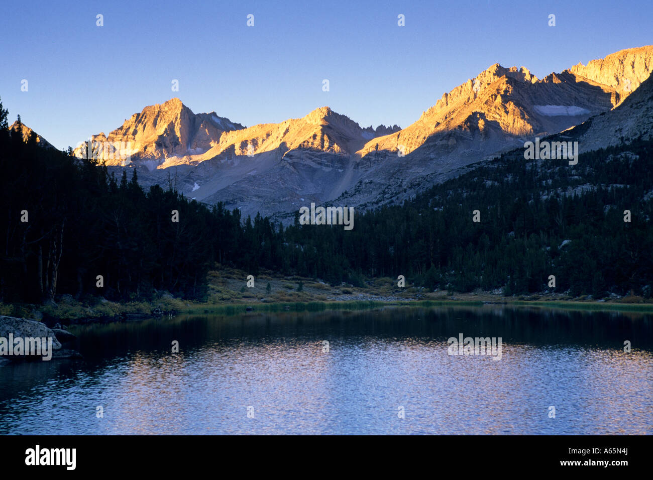 Sunrise light on Bear Creek Spire over Mack Lake, Little Lakes Valley ...