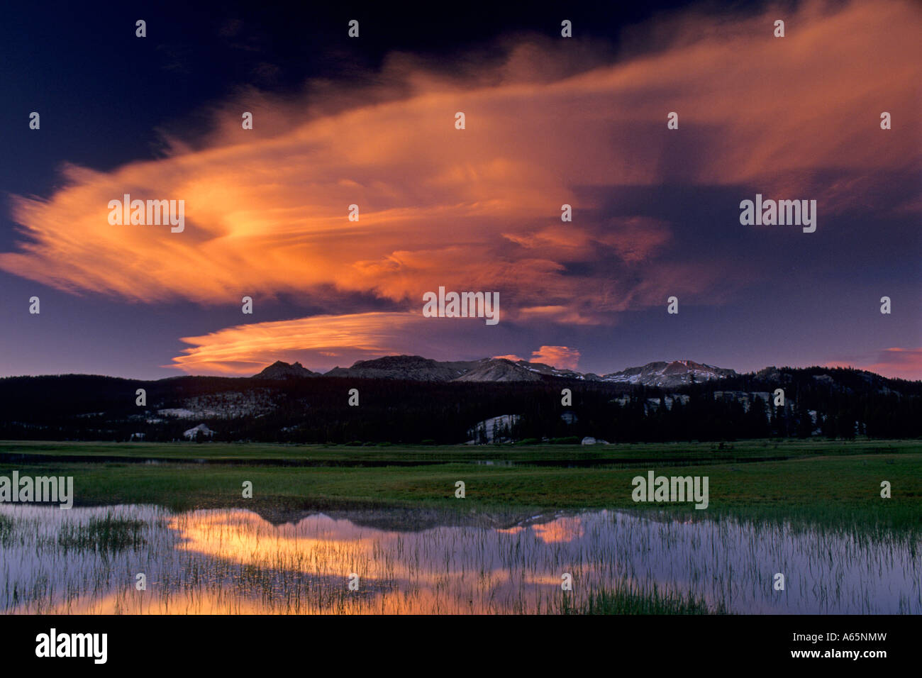 Lenticular cloud reflection sunset over Ragged Peak and Tuolumne ...