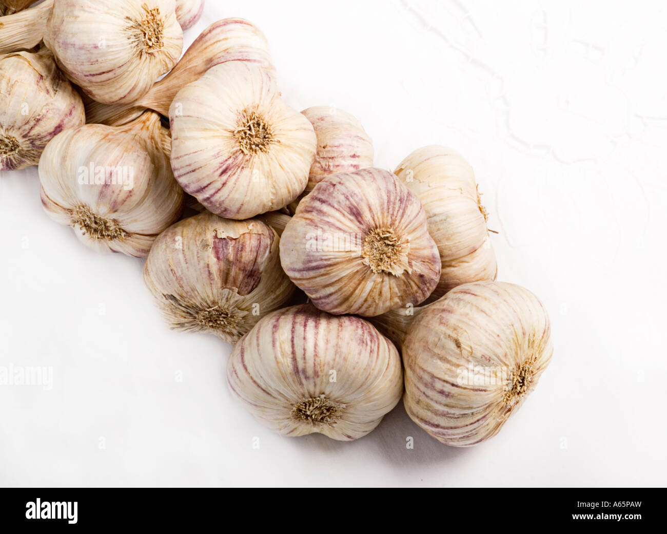 String of garlic on white background Stock Photo - Alamy