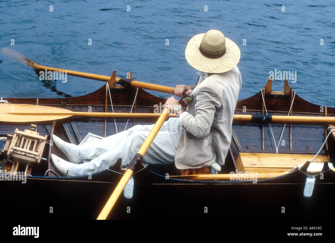 A man in Victorian costume rowing a double skiff on the River Thames at ...
