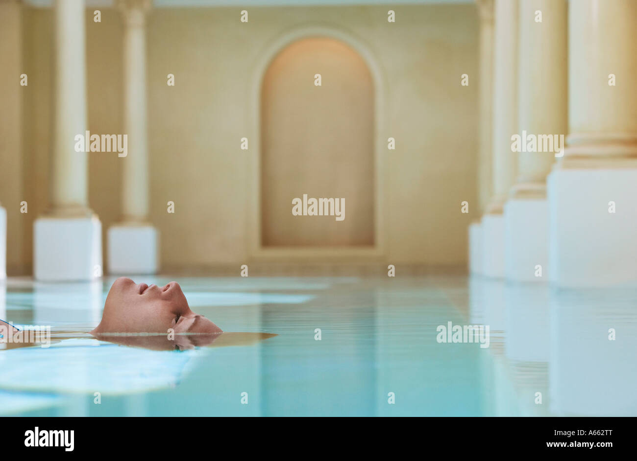 Young woman lying on back in swimming pool, portrait Stock Photo - Alamy