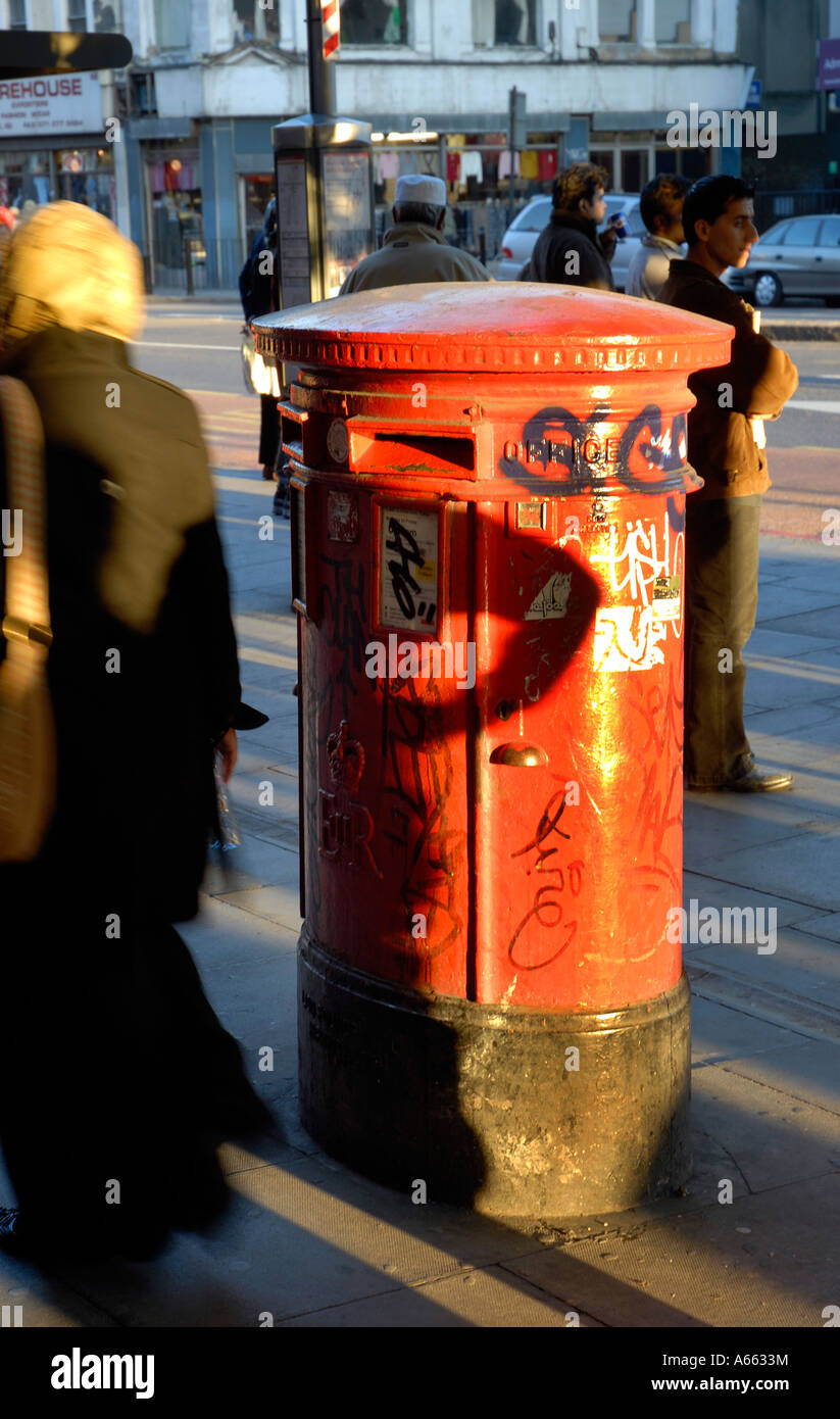 Graffiti covered postbox in the Whitechapel Road in Whitechapel London ...