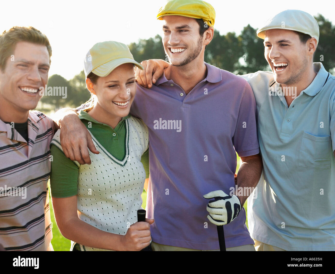 Smiling group young golfers with arms around each other's shoulders on ...