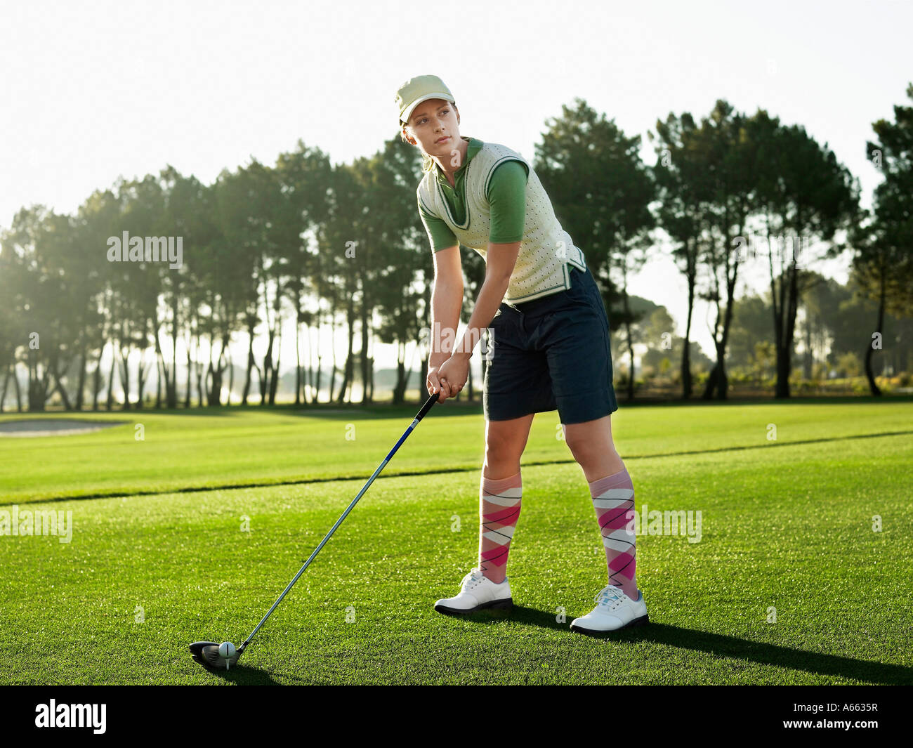 Young female golfer teeing off Stock Photo - Alamy
