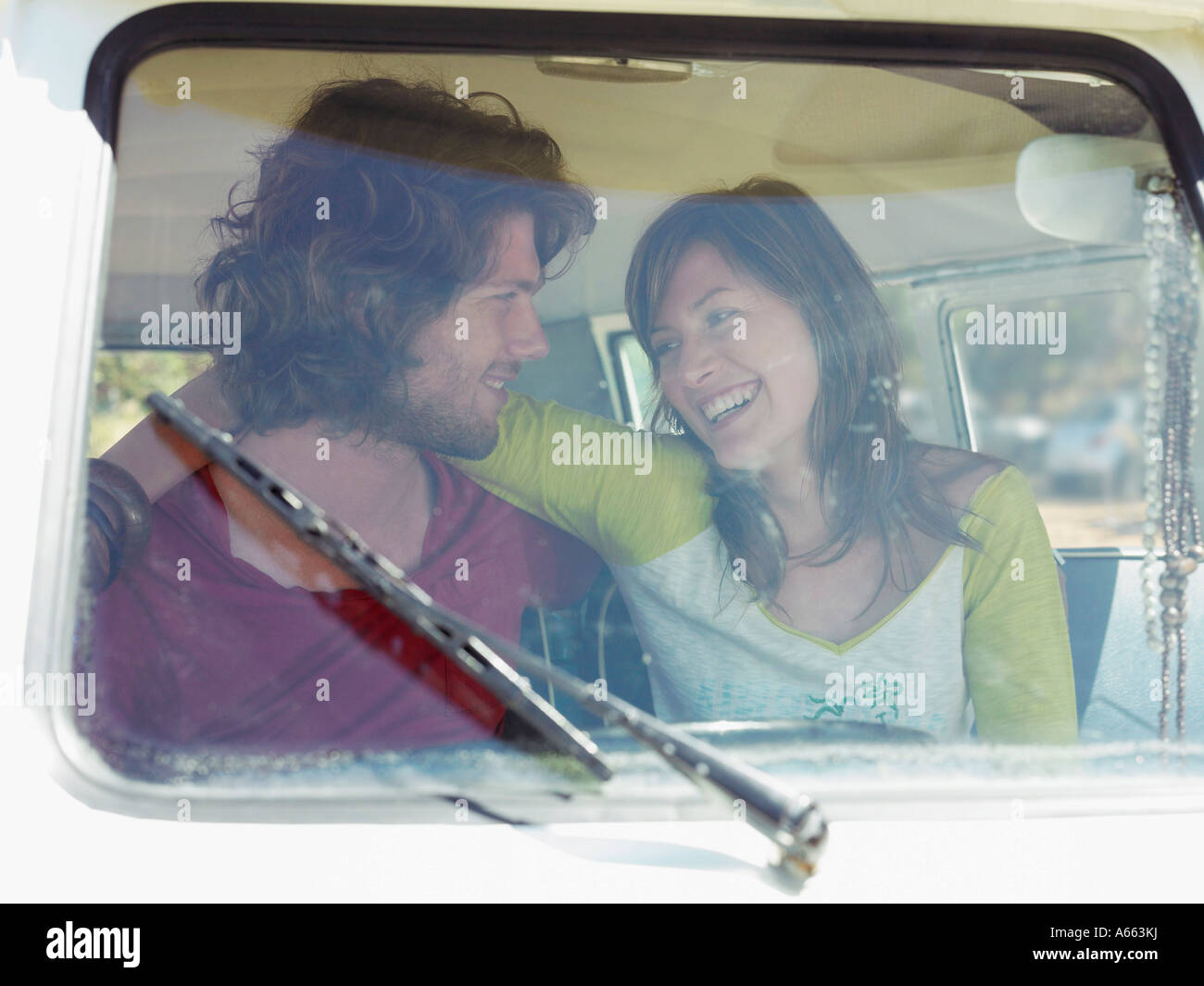 Young couple in van, view through window screen Stock Photo - Alamy