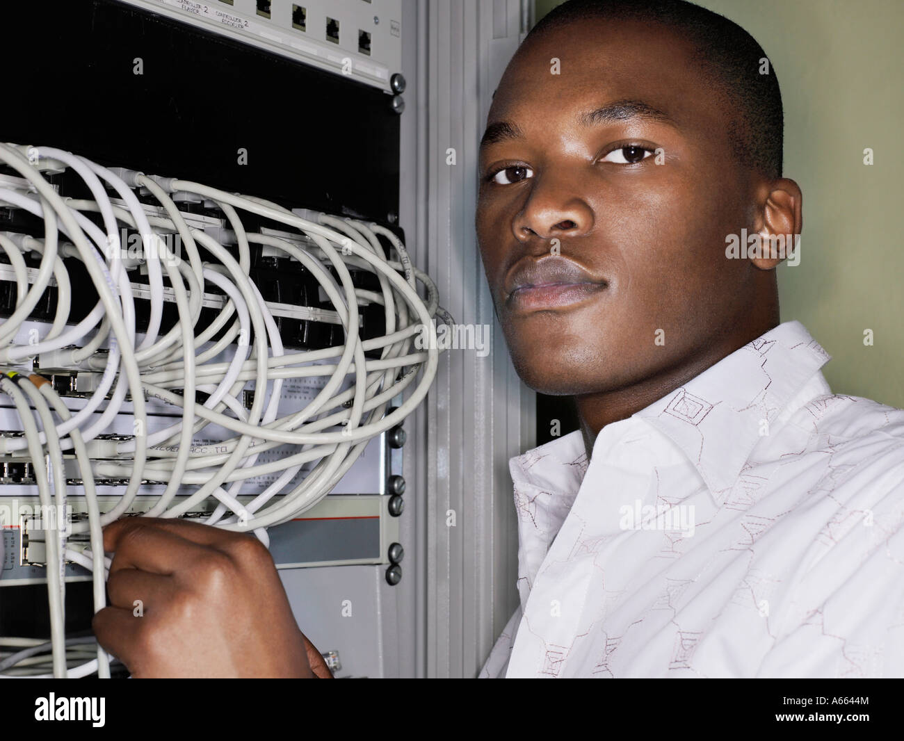 Man connecting network cables Stock Photo - Alamy