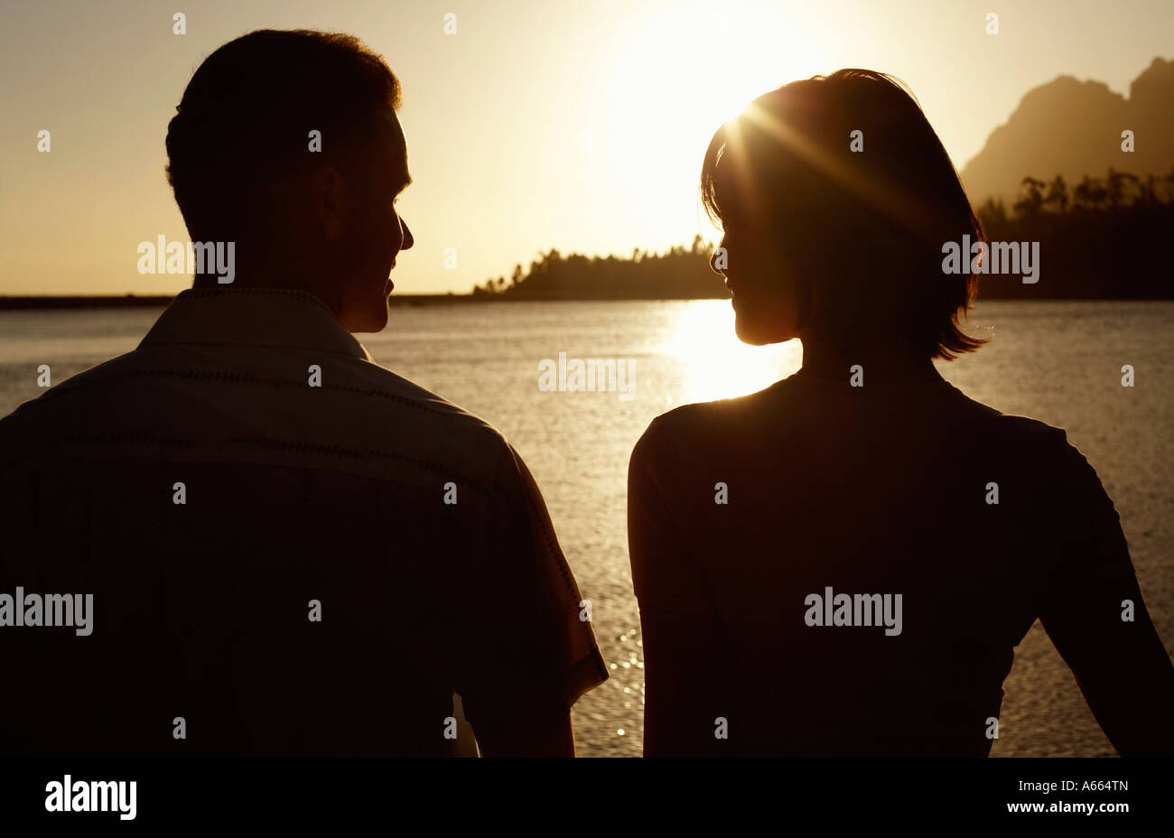 Couple standing by lake, back view Stock Photo - Alamy