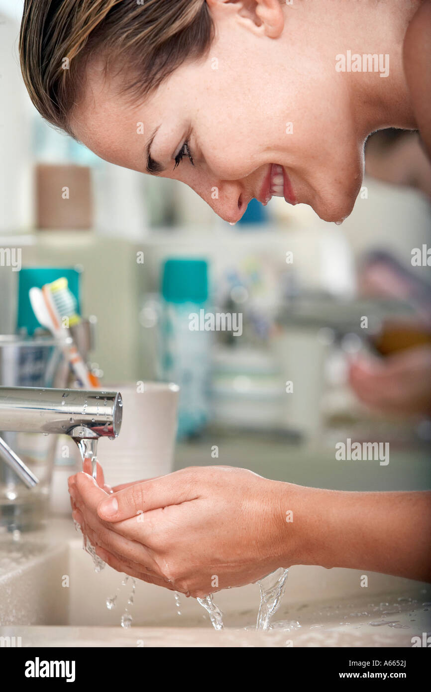 Woman washing face in bathroom, close-up Stock Photo - Alamy