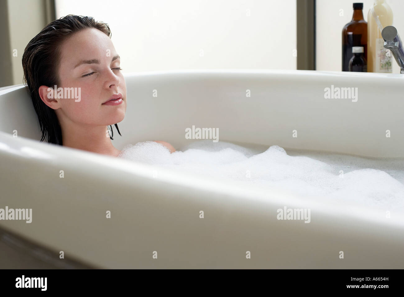 Young woman relaxing in bubble bath, eyes closed Stock Photo - Alamy