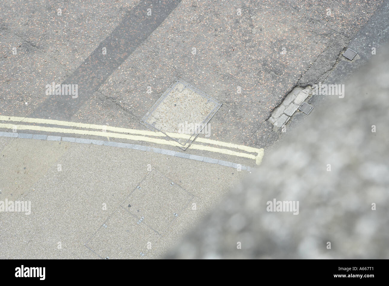 Double yellow lines on a road Stock Photo - Alamy
