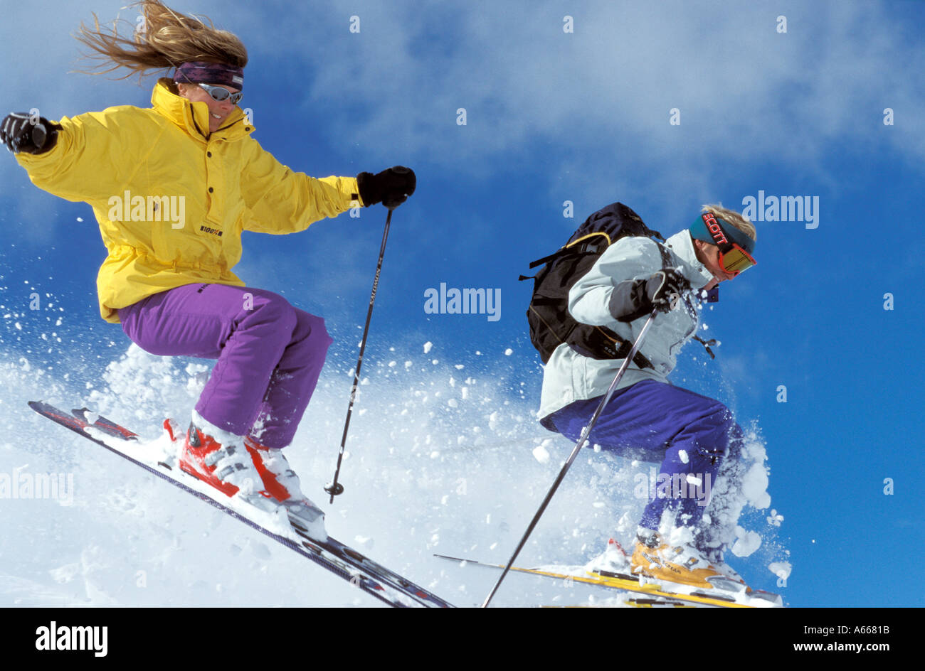 2 skiers jumping against blue sky Full frame Stock Photo - Alamy