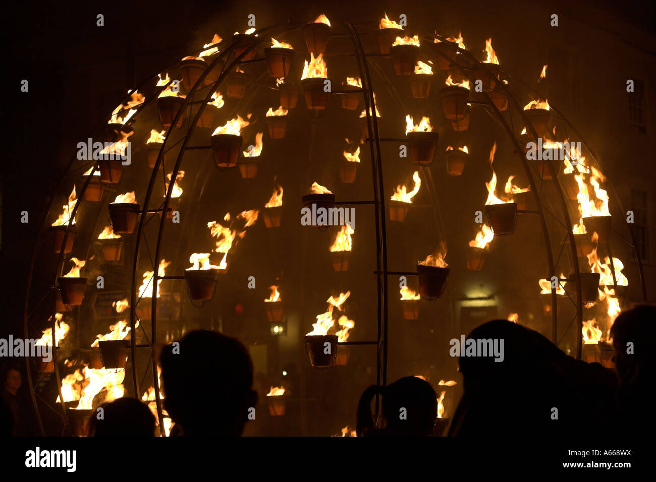 Large [ball of fire], art sculpture made of ceramic fire pots lit at ...