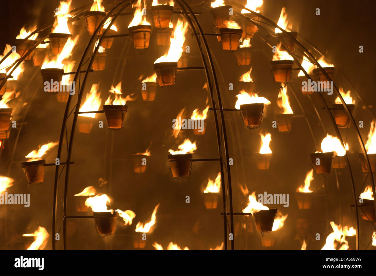 Large [ball of fire], art sculpture made of ceramic fire pots lit at ...