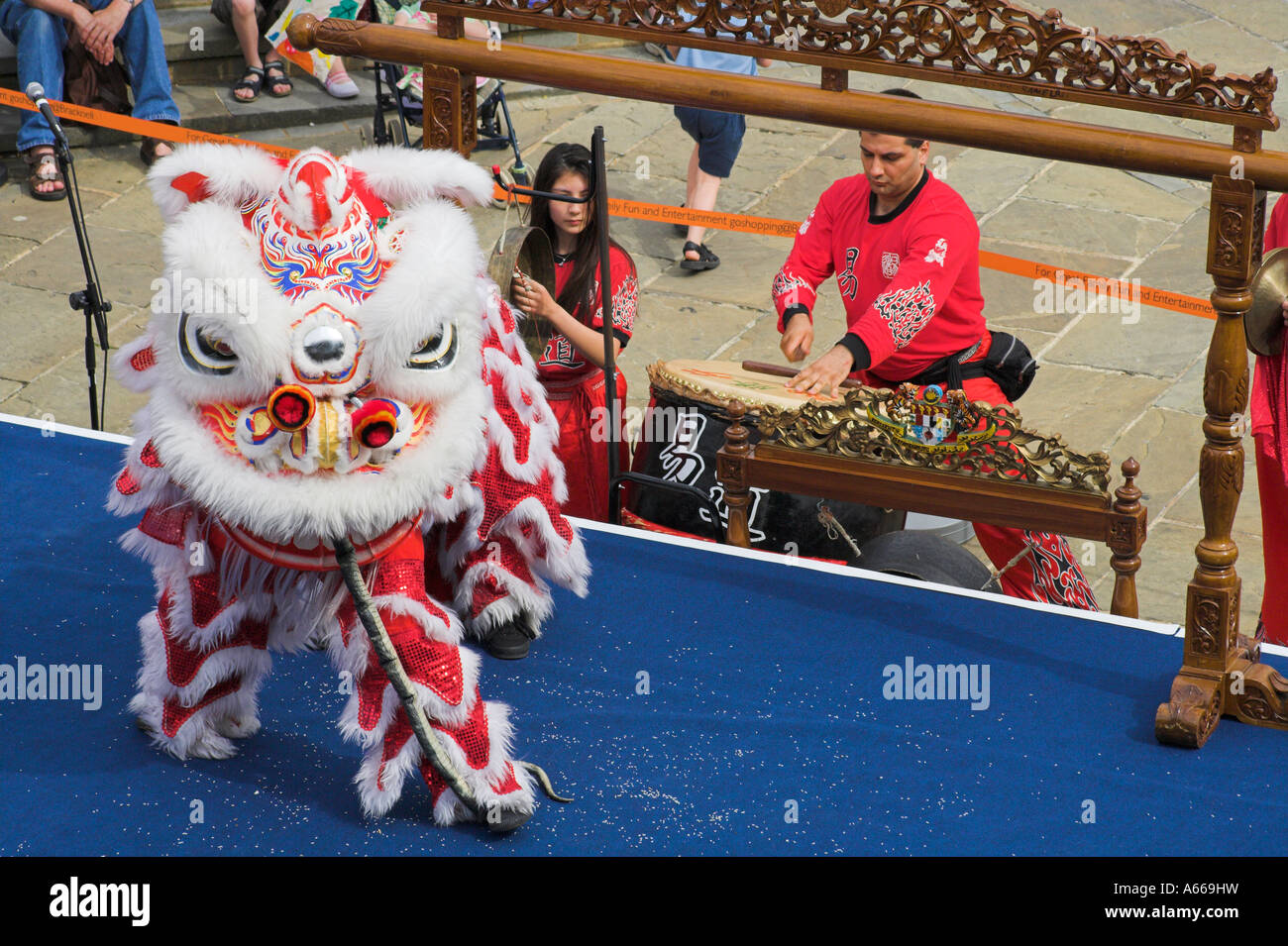 Malaysian Lion Dance Troupe Lion stretches snake Stock Photo - Alamy