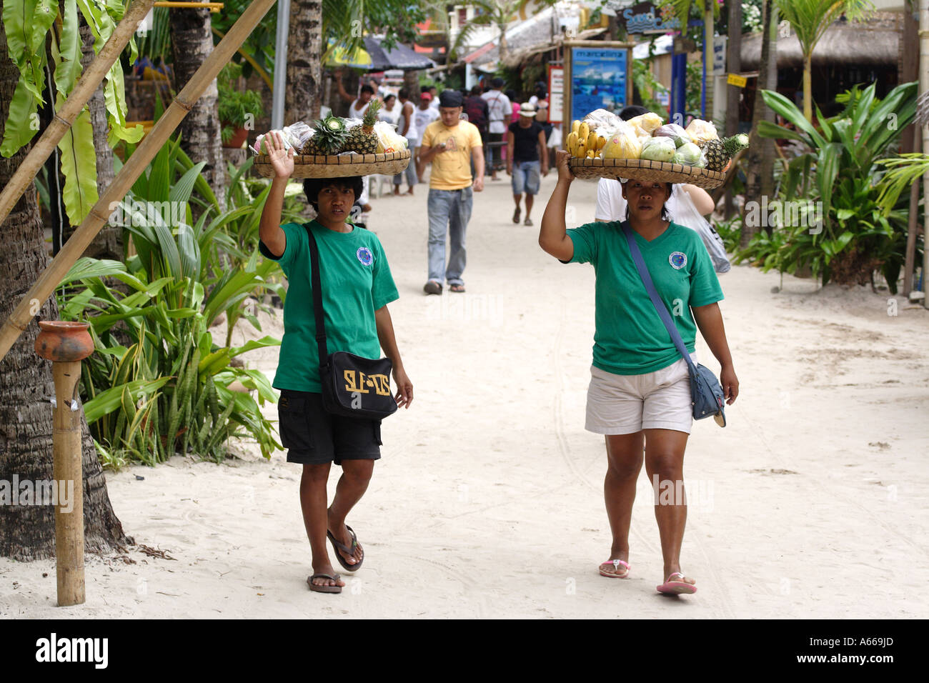Boracay, Philippine Islands, Two women carrying things to sell on their ...