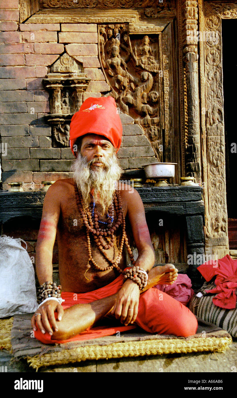 Portrait of a holy man sits in front of a temple in Kathmandu in Nepal ...