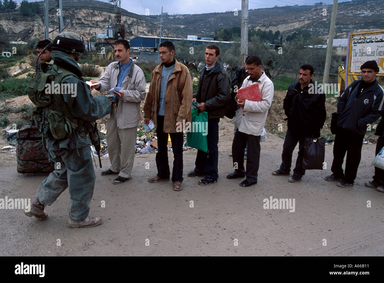 Israeli soldier checking identity cards of Palestinians at Nablus check ...