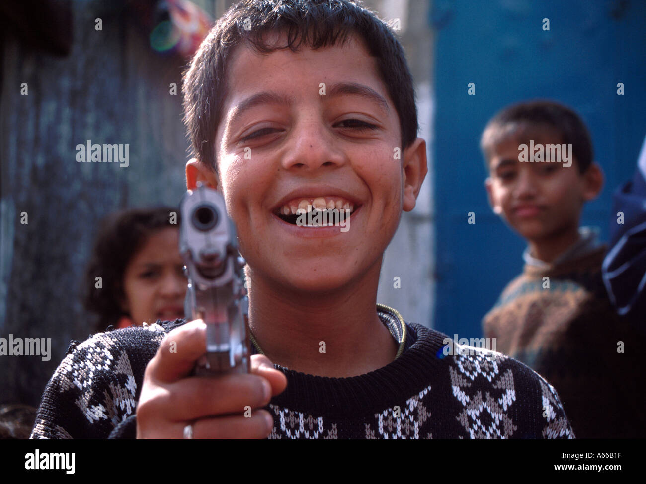 Palestinian boy playing with toy gun Rafah Stock Photo - Alamy