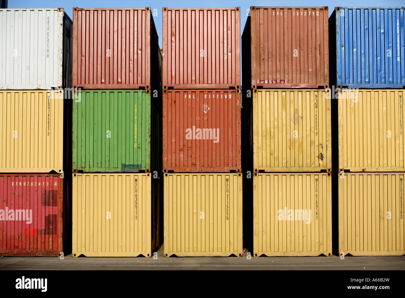coloured shipping containers stacked on a dockside Stock Photo - Alamy