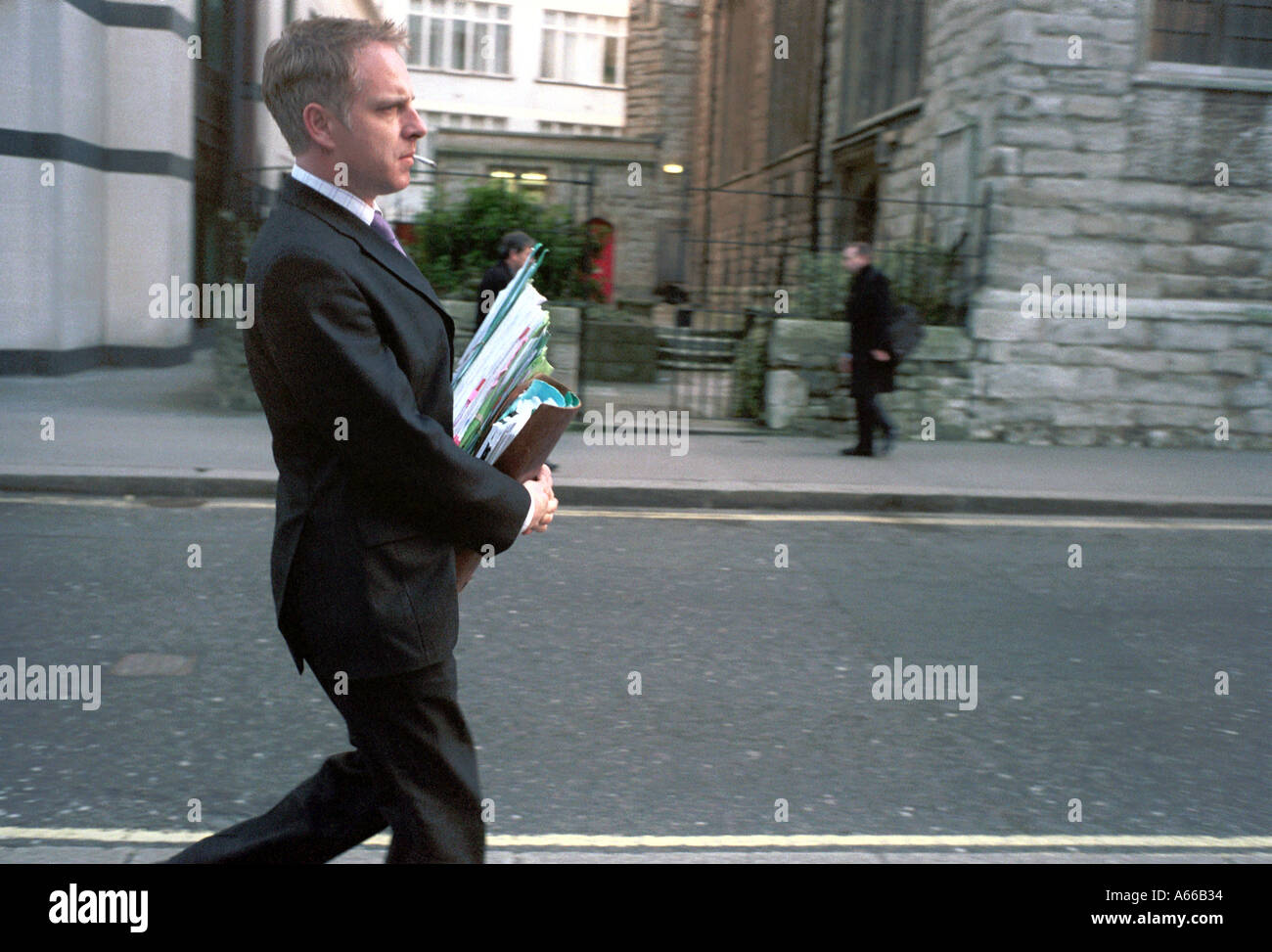 Man carrying pile of office paper in the city of London, England ...