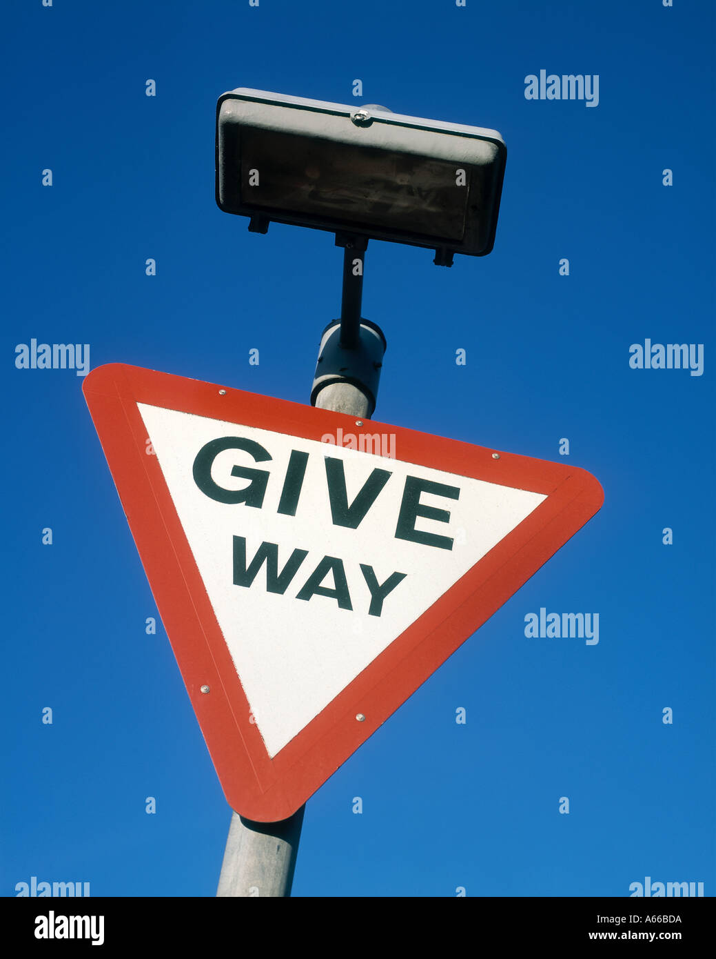 GIVE WAY ROAD TRAFFIC SIGN WITH BLUE SKY Stock Photo - Alamy