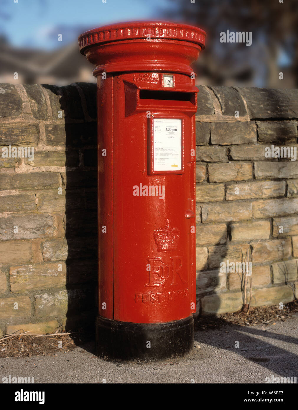 RED ROYAL MAIL PILLAR BOX WITH STONE WALL Stock Photo - Alamy