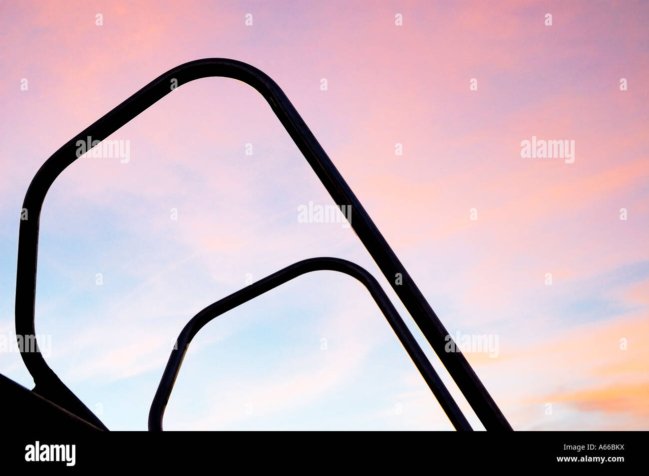 silhouettes of metal railings on a kids playgound in the uk Stock Photo ...