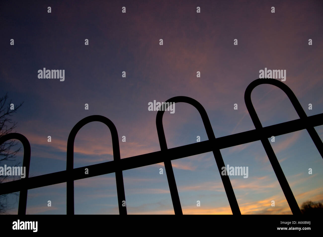 silhouettes of metal railings on a kids playgound in the uk Stock Photo ...