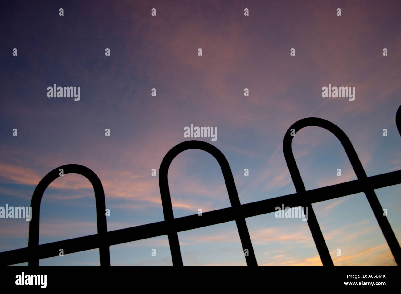 silhouettes of metal railings on a kids playgound in the uk Stock Photo ...