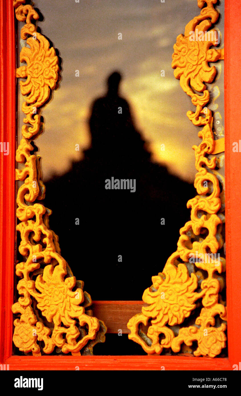 Buddha reflected on a window glass at the Po Lin Monastery in Hong Kong ...