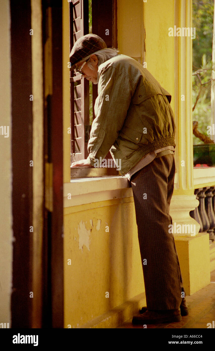 Old man contemplates life through a window in Macau Stock Photo - Alamy