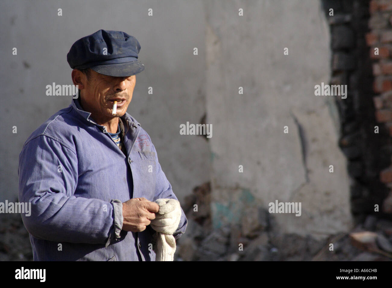 Beijing man lights up a cigarette in the Hutong Stock Photo - Alamy