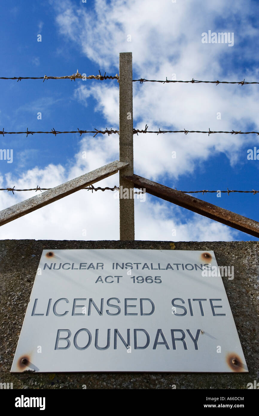 Licensed site boundary sign and barbed wire against blue sky Stock ...