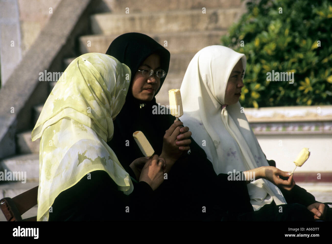 Three Hui muslim girls enjoying icecream in the courtyard of the ...