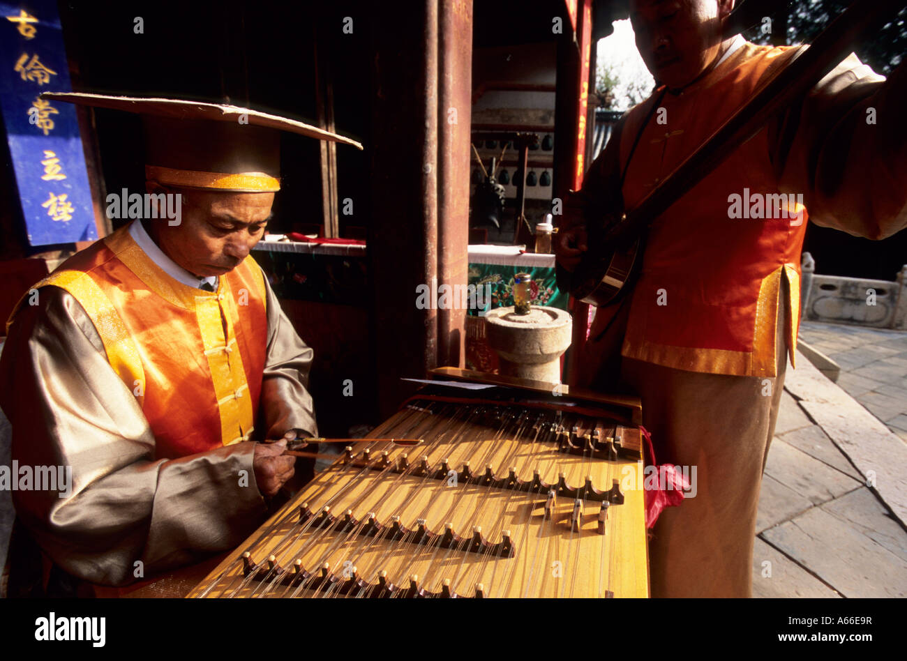 Musicians in traditional dress playing classical Chinese instruments in ...