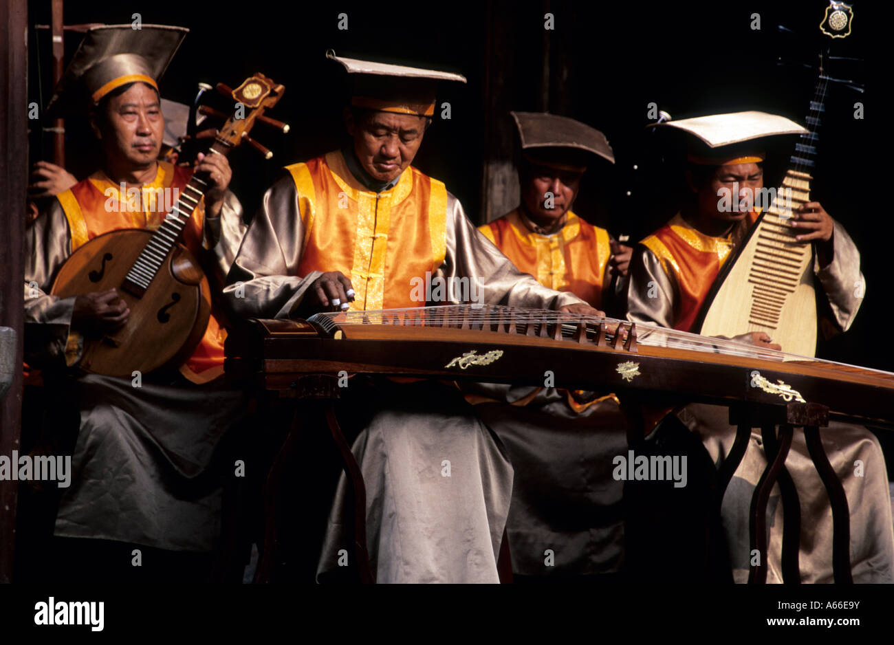 Musicians in traditional dress playing classical Chinese instruments in ...