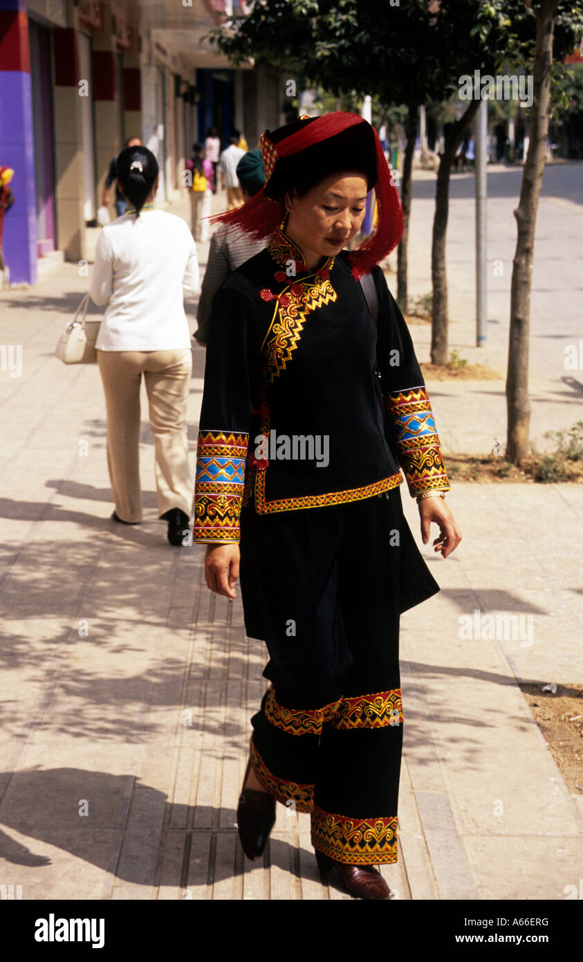 Woman of Hani ethnic minority in traditional dress walking on the ...