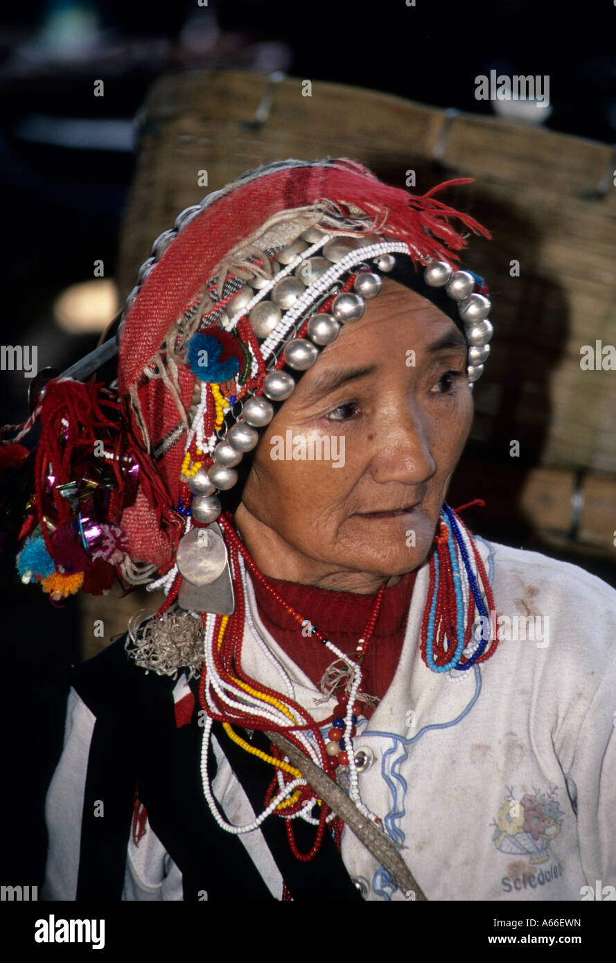 Akha woman with traditional headgear on the market of Menghai ...