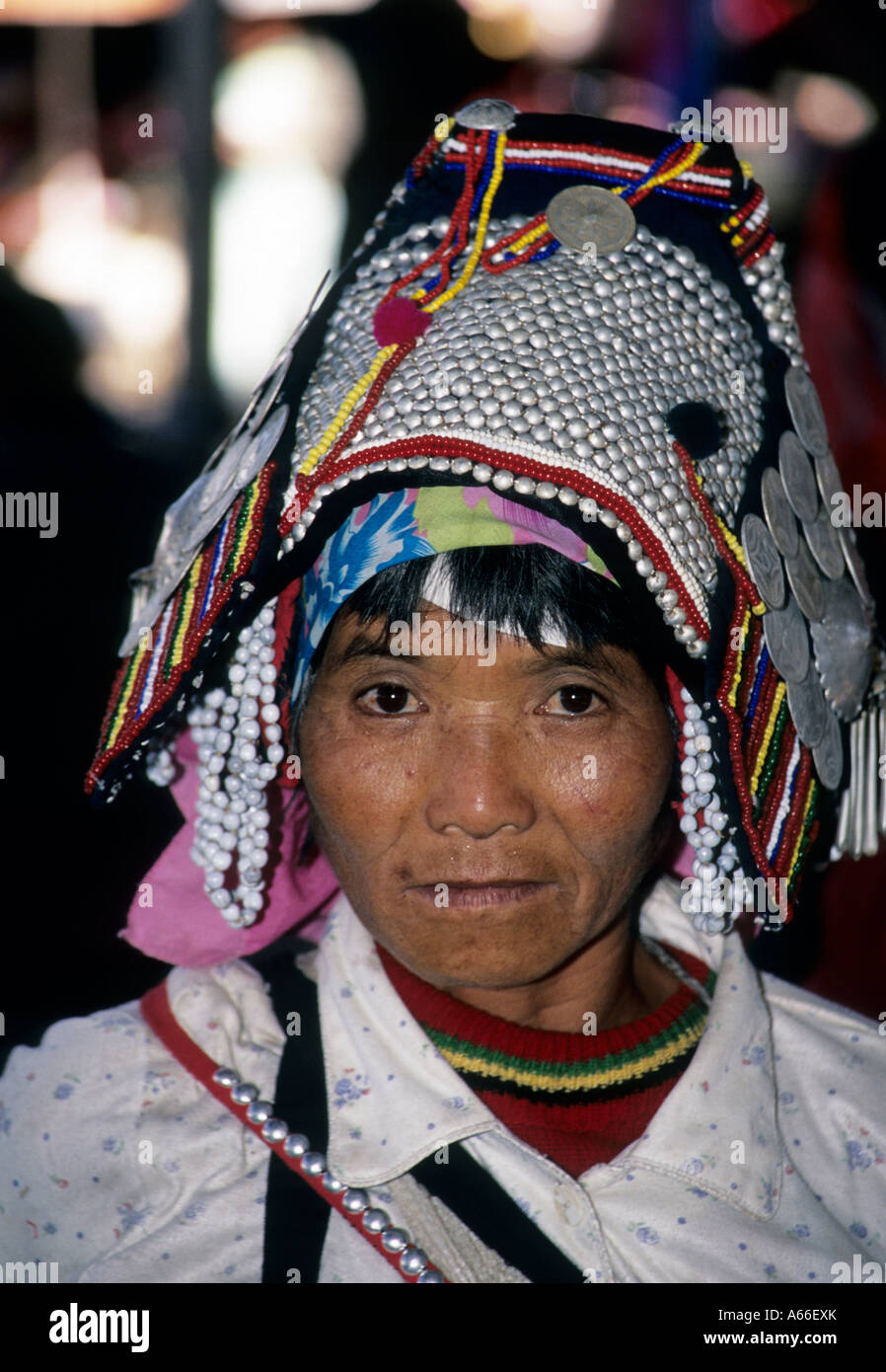 Akha woman with traditional headdress on the market of Menghai ...