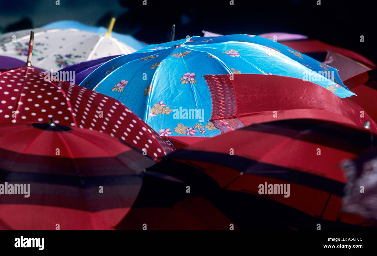 Bright coloured silk umbrellas used by women attending a buddhist ...