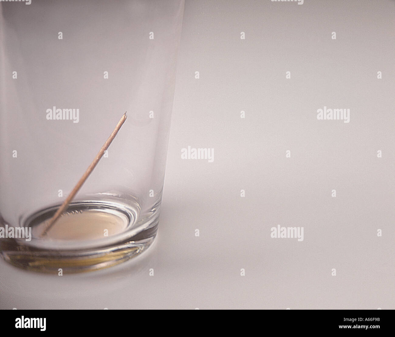 colour image off a empty glass with a broken cocktail stick inside it ...