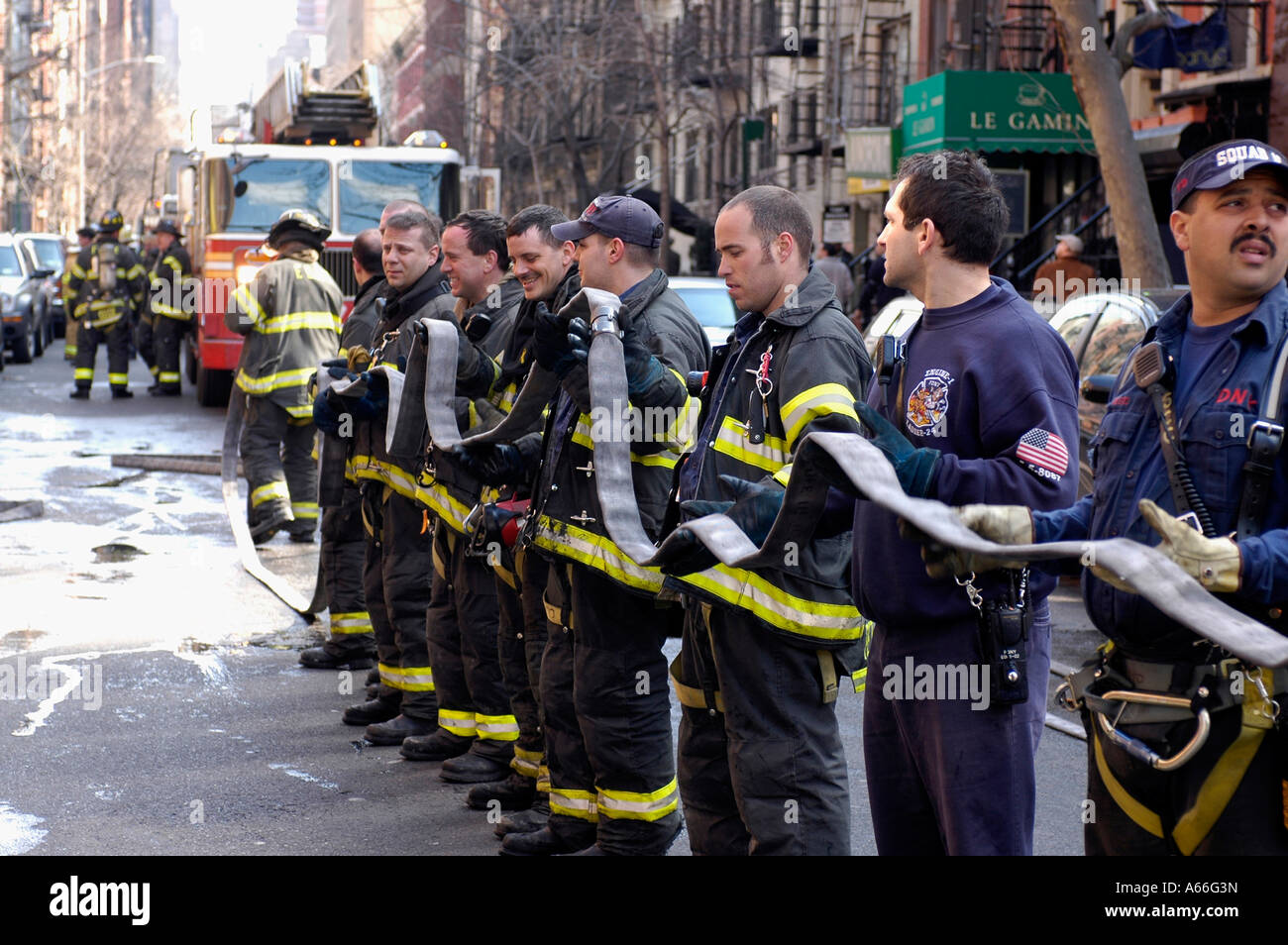 Firefighters from the FDNY pack up their hoses after fighting a smoky ...