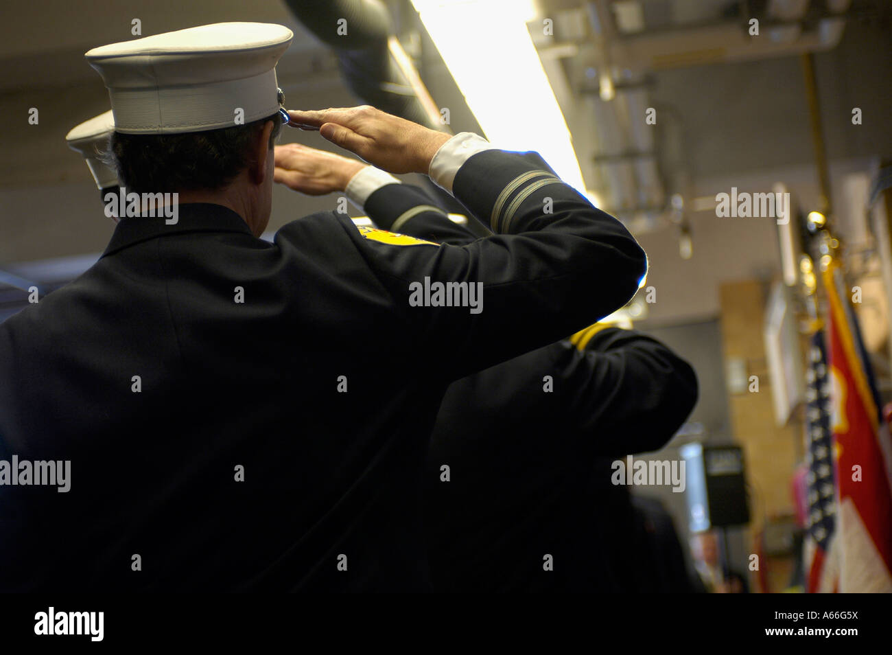 Members of the FDNY salute the flag during a memorial service in NYC ...