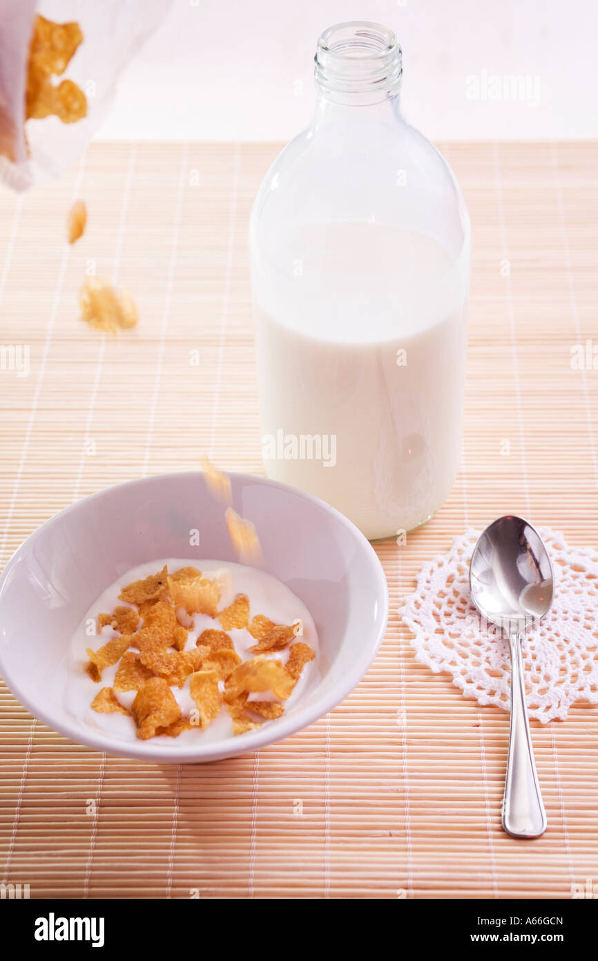 Pouring flakes into the breakfast bowl Stock Photo - Alamy
