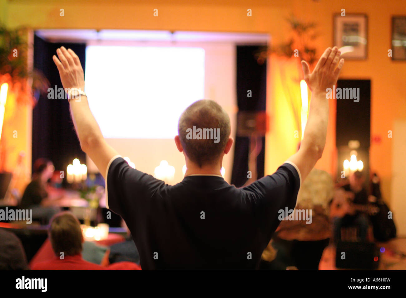 man worshipping God with hands in the air Stock Photo - Alamy
