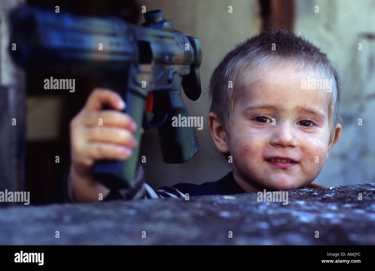 Child playing with a toy gun Stock Photo - Alamy